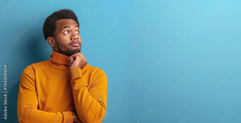 A Mans Pensive Expression Against a Stark Blue Background, Reflecting ...