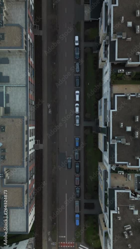 A top aerial, vertical view of a modern street in an apartment complex ...