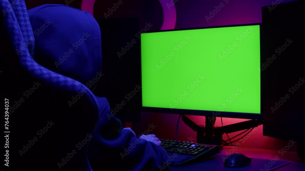 Computer with chroma key green screen on monitor. Gamer man playing in ...
