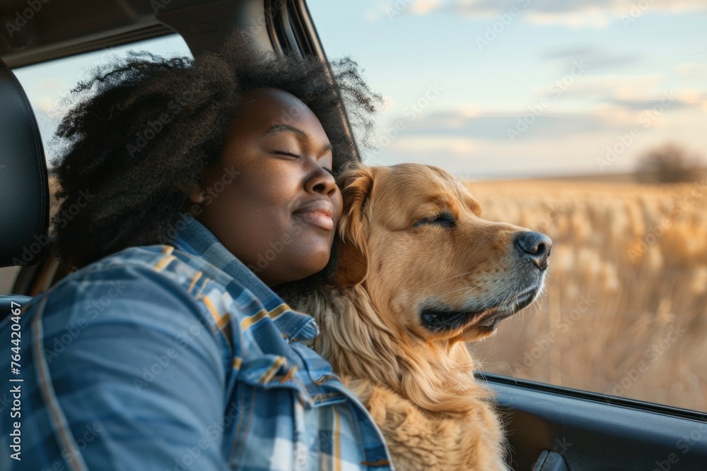 Relaxed woman and her golden retriever enjoying a peaceful car ride ...