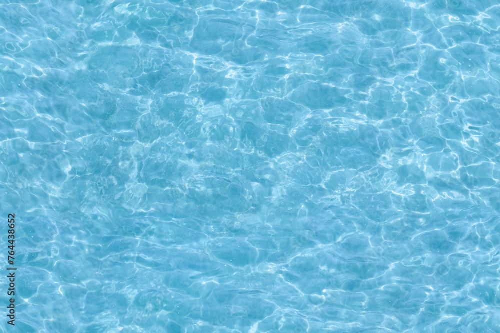 An aerial view of a large region of clean, clear, blue water ripples ...