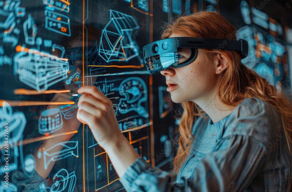 Female engineer wearing a virtual reality headset, pointing at a ...