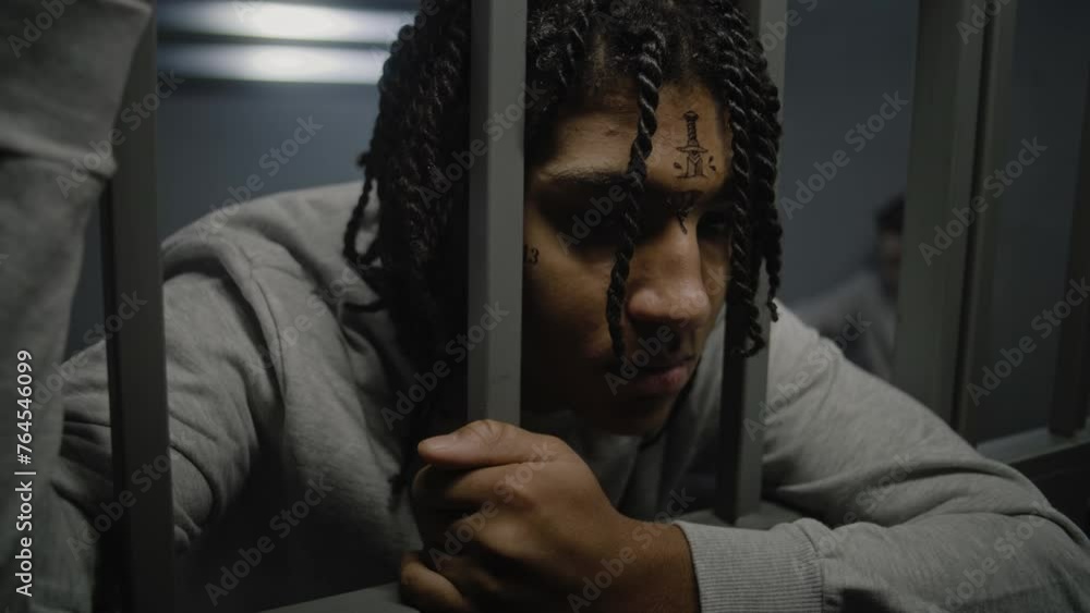 Close up shot of angry African American teenage prisoner with face ...