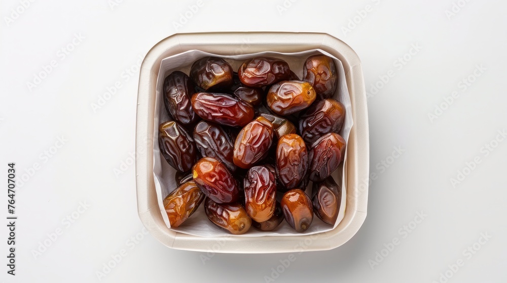 Big dates in a paper container isolated. Dry date fruits, medjool ...