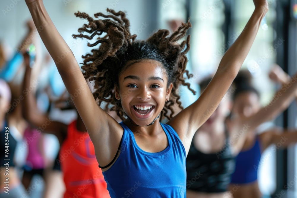 A young girl expressing joy and energy while participating in a dance ...
