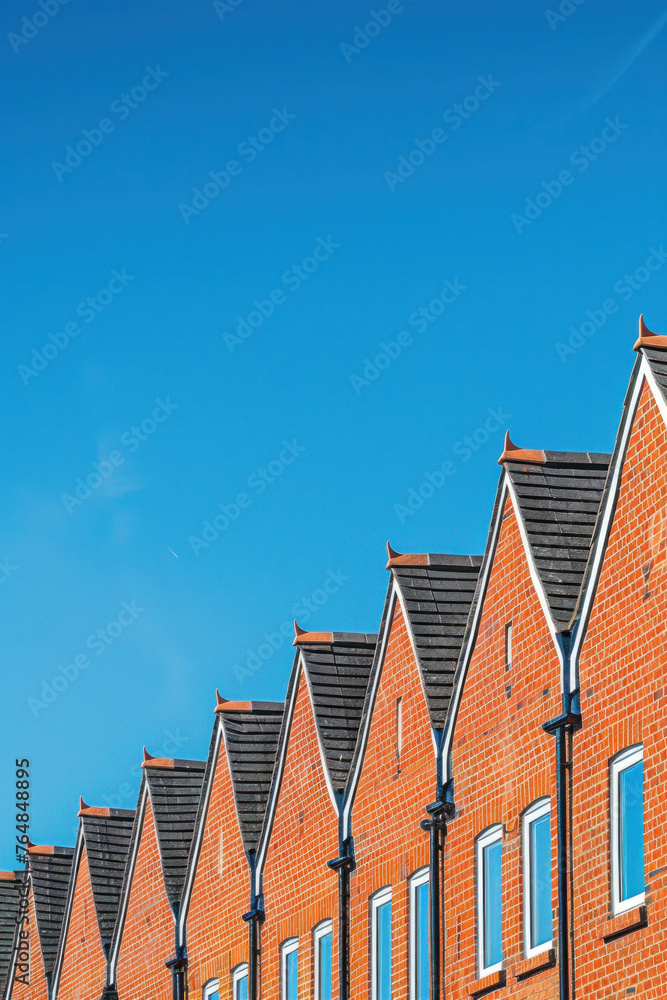 Row of colorful brick cottages, red brick country houses, blue sky ...