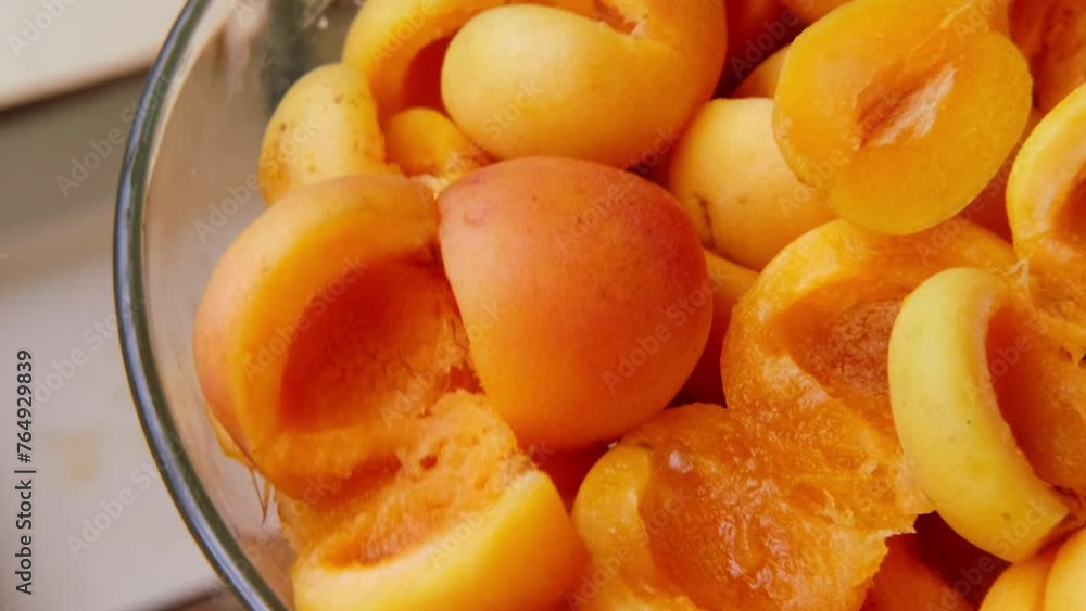 Close-up of female hands removing pits from ripe apricots, concept ...