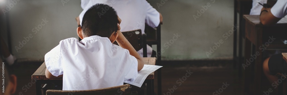 Stressed Student taking exam in classroom.Assessment examination of ...