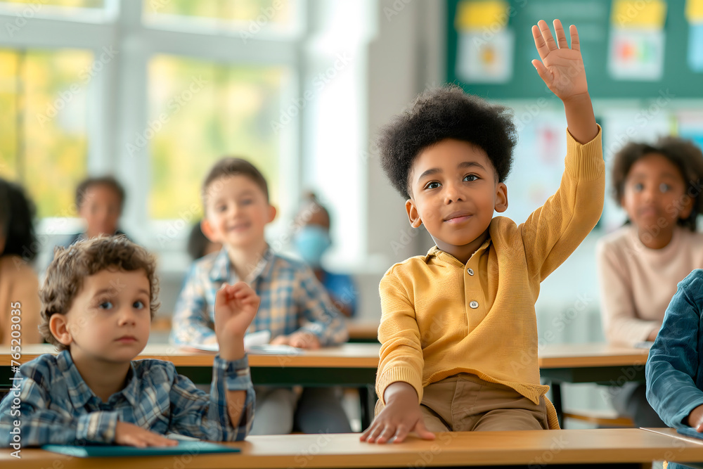 portrait of 7-year-old black boy sitting in modern classroom among ...