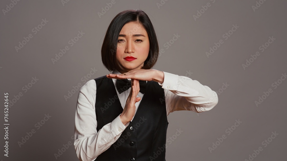 Asian receptionist expressing timeout symbol on camera, showing ...