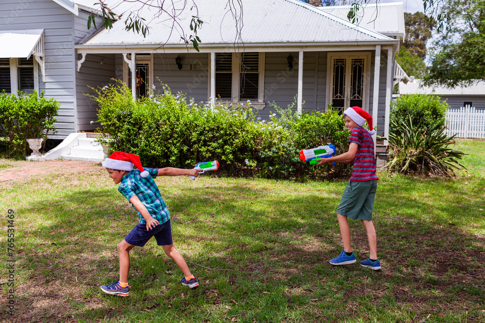 Brothers pointing blaster pistols in Christmastime water fight Stock ...