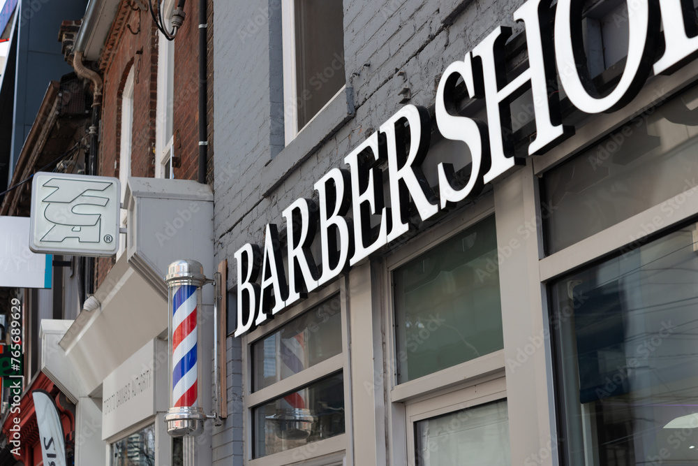 exterior building facade barber pole and sign of Tower Barber Shop ...