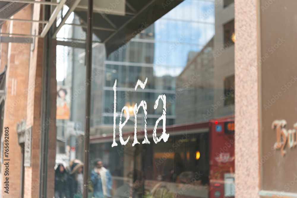 exterior building facade display window and sign of Leña Restaurante, a ...