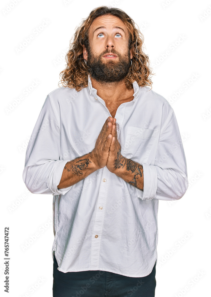 Handsome man with beard and long hair wearing casual clothes begging ...