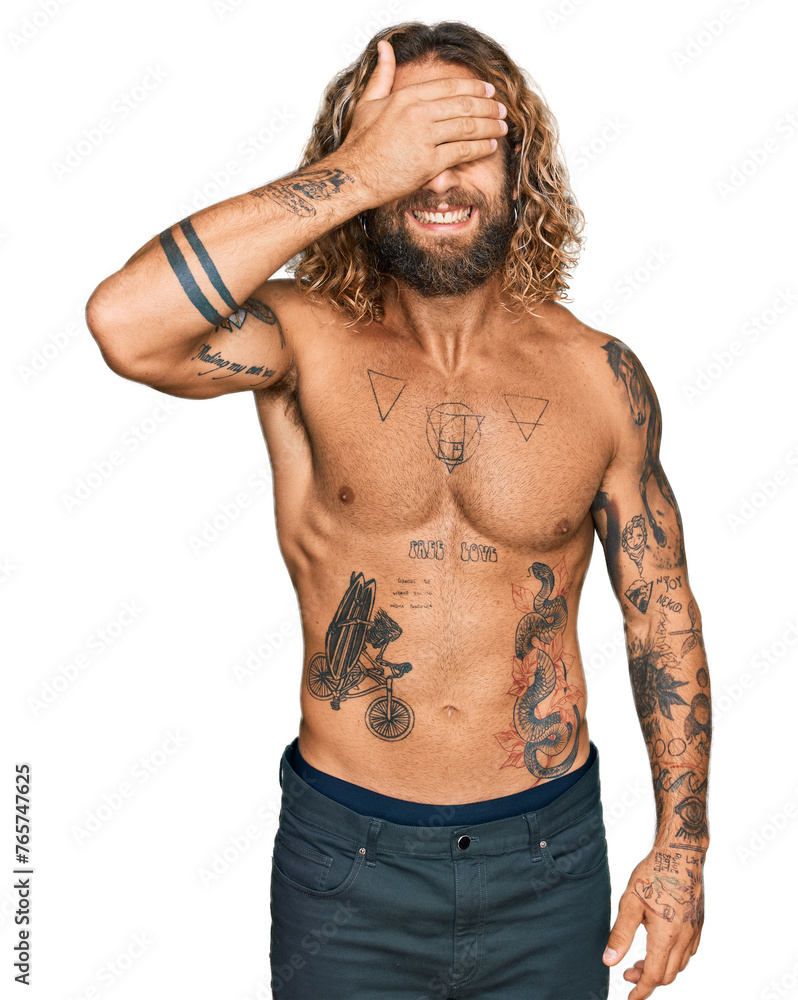 Handsome man with beard and long hair standing shirtless showing ...