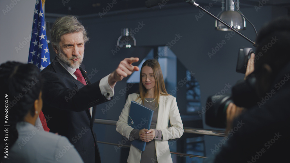 Positive American politician comes to journalists and poses for cameras ...