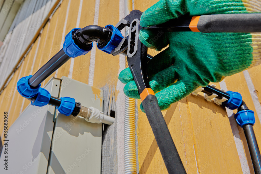 Plumber adjustable pipe pliers are used when installing an outdoor cold ...