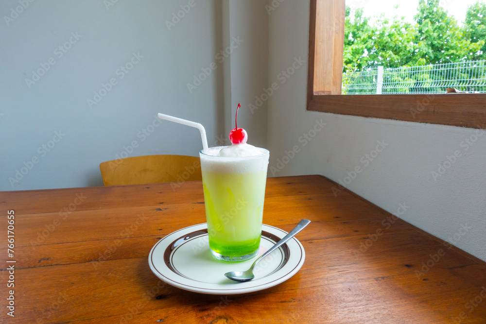 Melon soda float with vanilla ice cream and cherry on top in summer ...