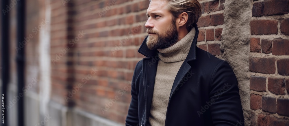 A man with facial hair and a beard is leaning against a brick wall ...