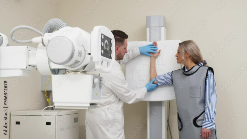 The doctor prepares the patient for an X-ray of the arm. Preparing for ...
