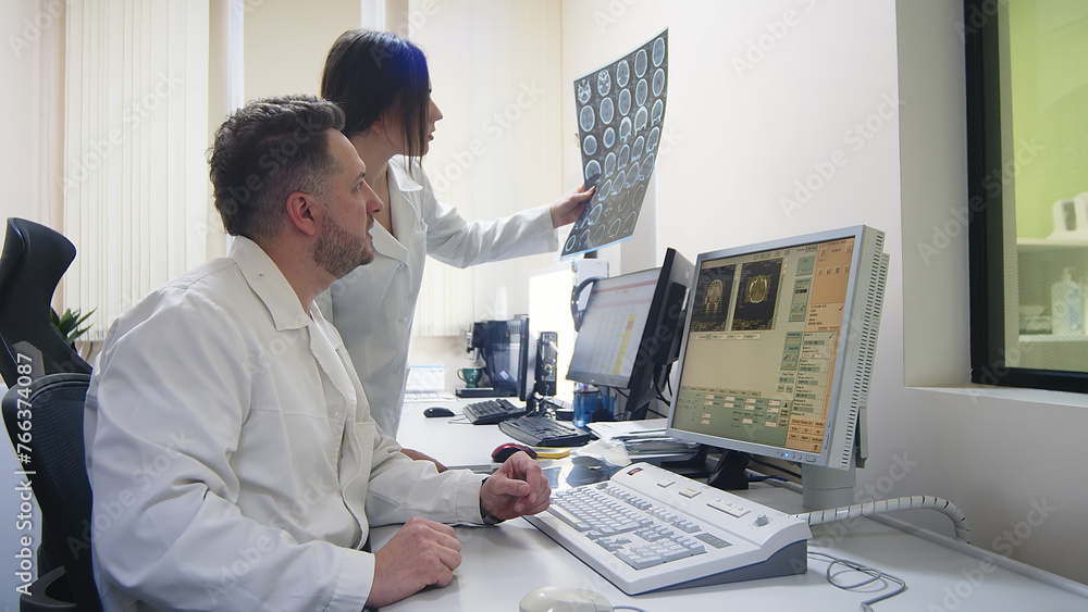 In a medical laboratory, the patient undergoes an MRI or CT scan under ...