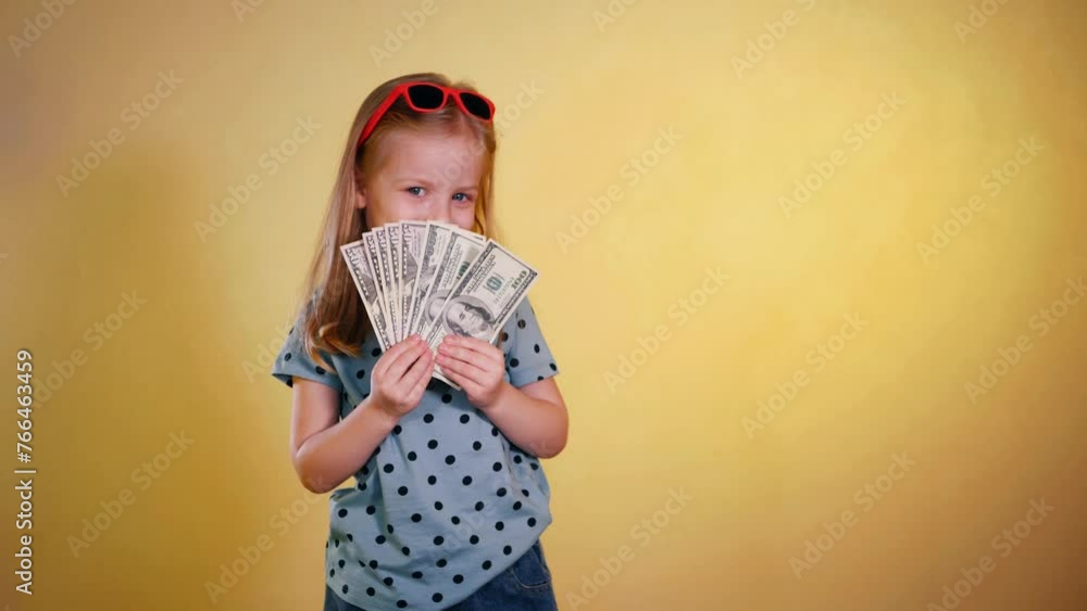 Video Stock A little girl gleefully holding a handful of cash. Smiling ...