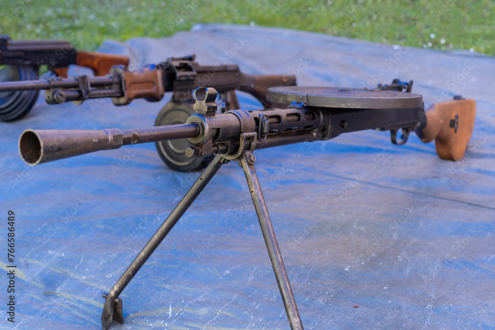 WW2 Soviet machine gun with round ammunition magazine on a blue ...