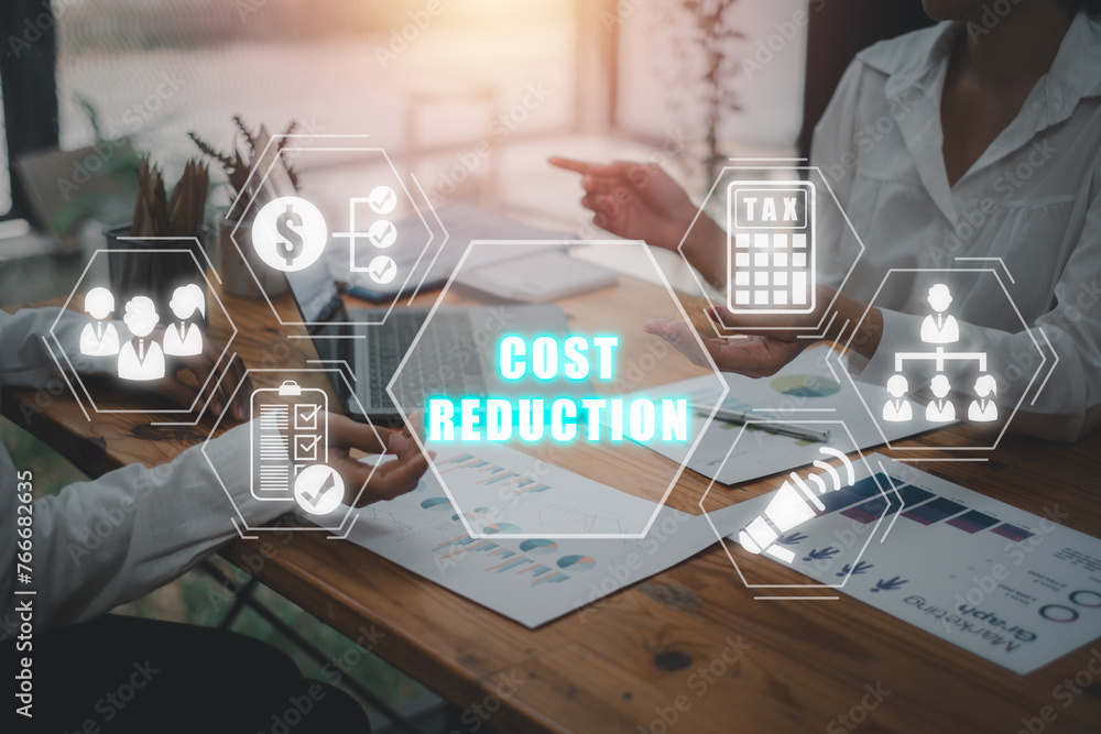 Cost reduction concept, Business team analyzing income charts and ...