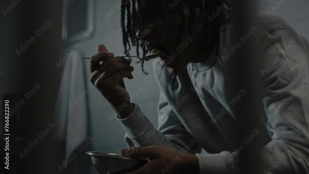 Close up of African American teenage criminal trying to eat disgusting ...