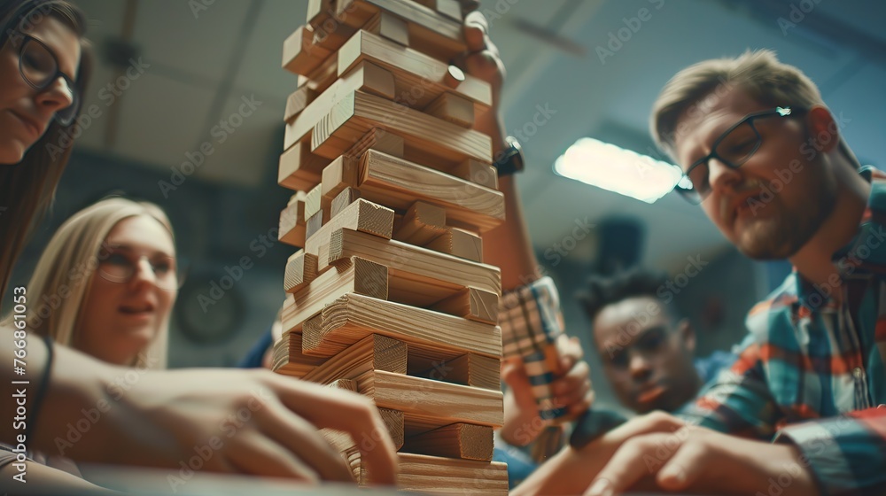 Business team colleagues playing jenga board game together, holding ...