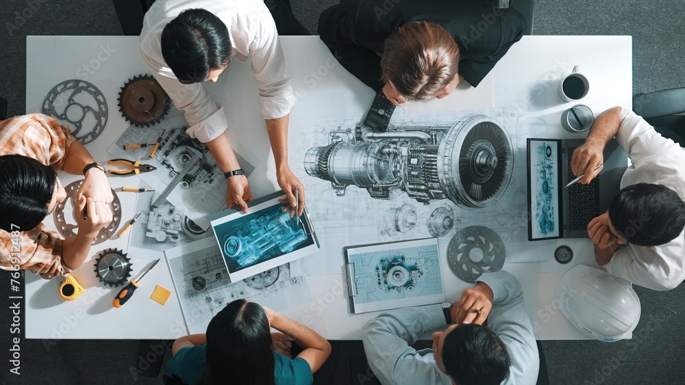 Top down aerial view of smart engineer team working together to design ...
