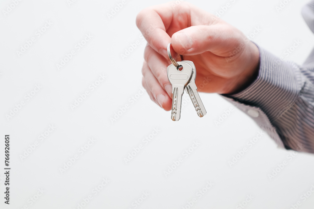 Hand holding house keys. Moving house, relocation. Caucasian male hand ...