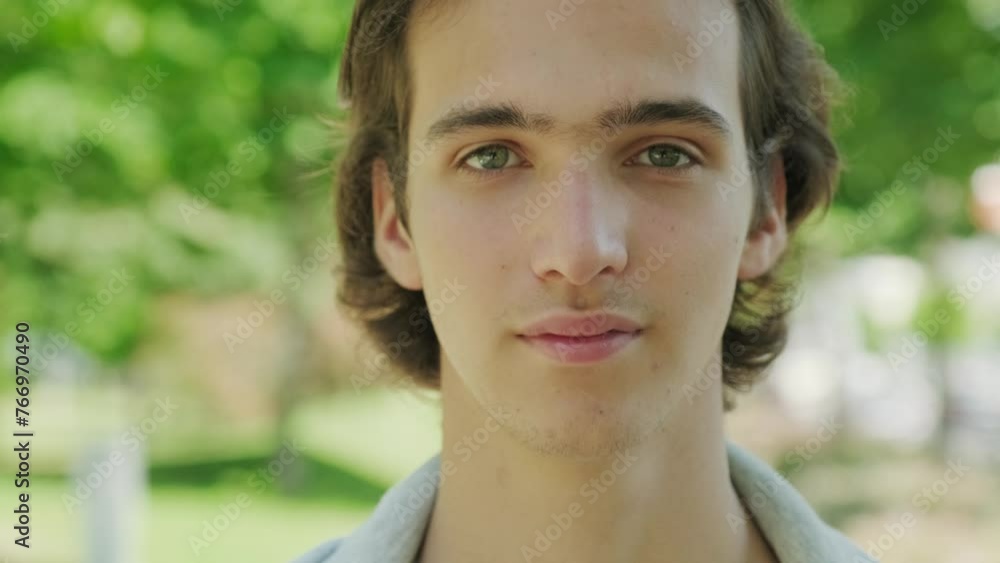 Calm and peace look of an young man . Happy Young man stands and looks ...