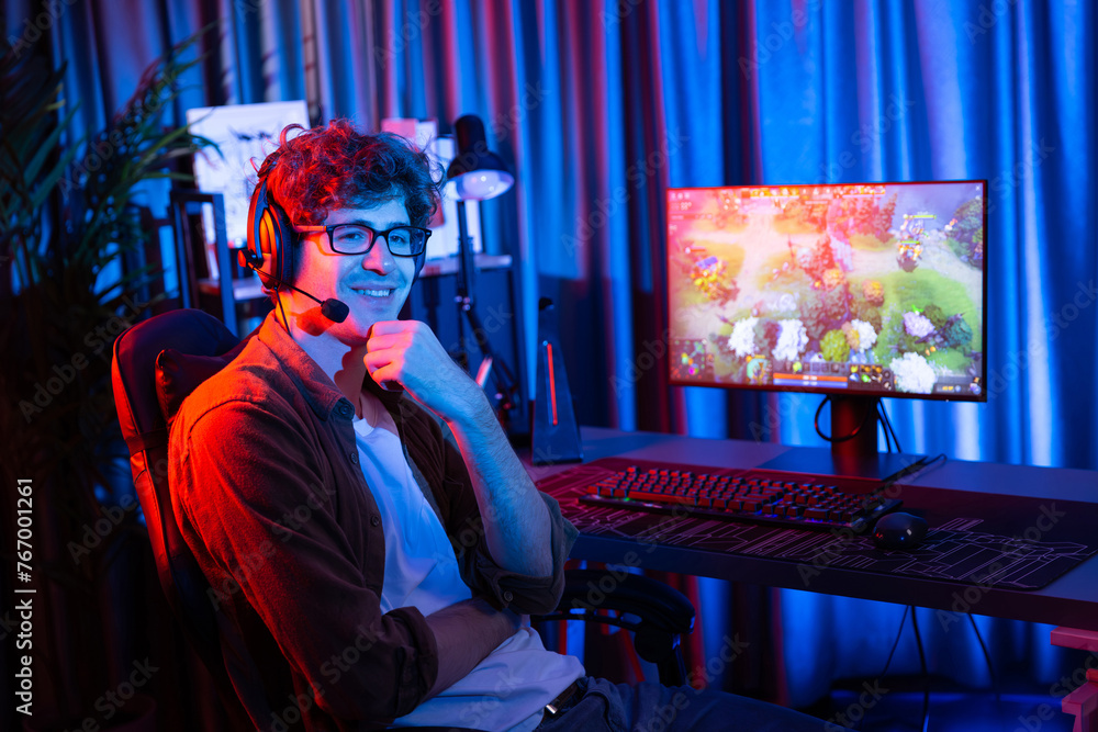 Host channel of young gaming streamer looking at camera to present ...