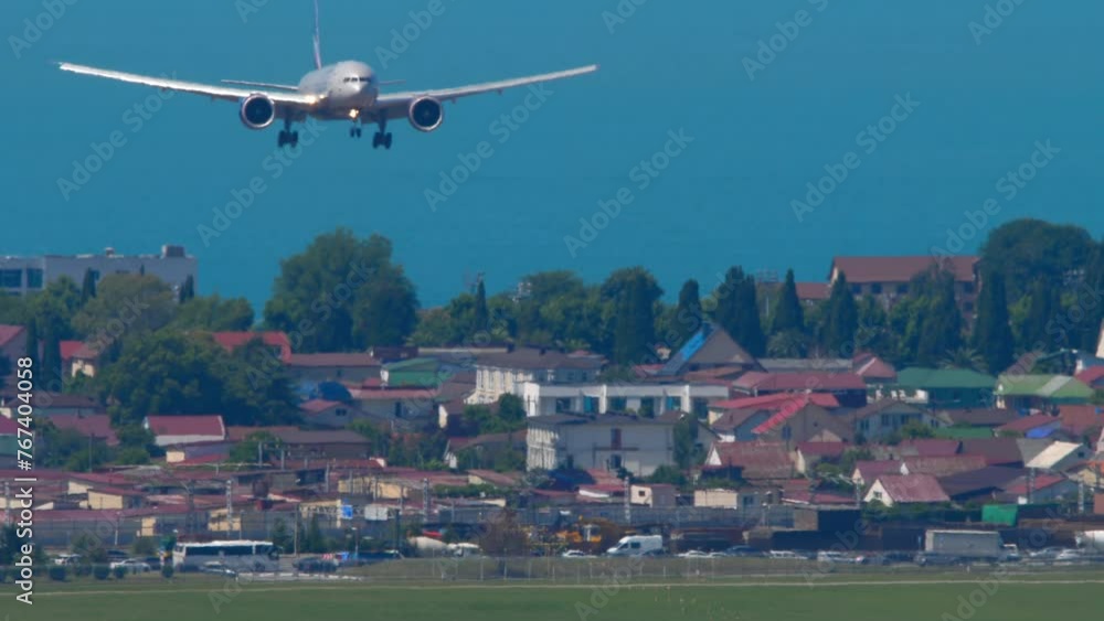 Airliner approaching landing, slow motion, front view. Jet plane with ...