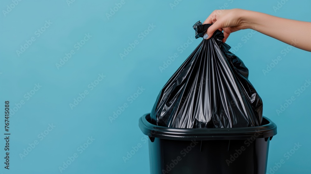 Closeup woman hand throwing away black polyethylene garbage bag on ...