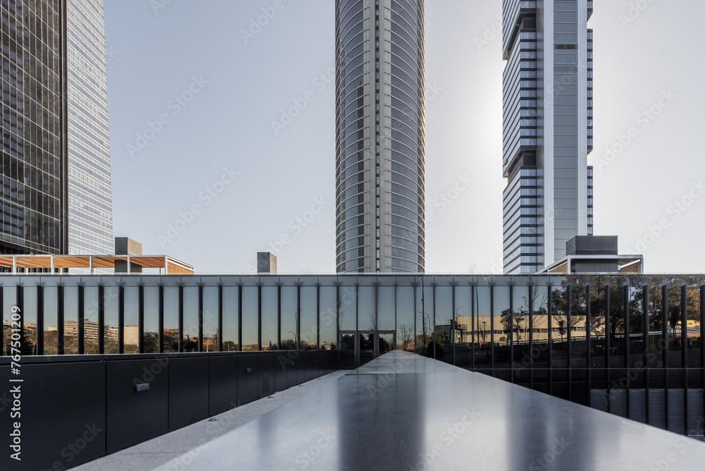 Wide railing of an access walkway to the ground floor of towers in the ...