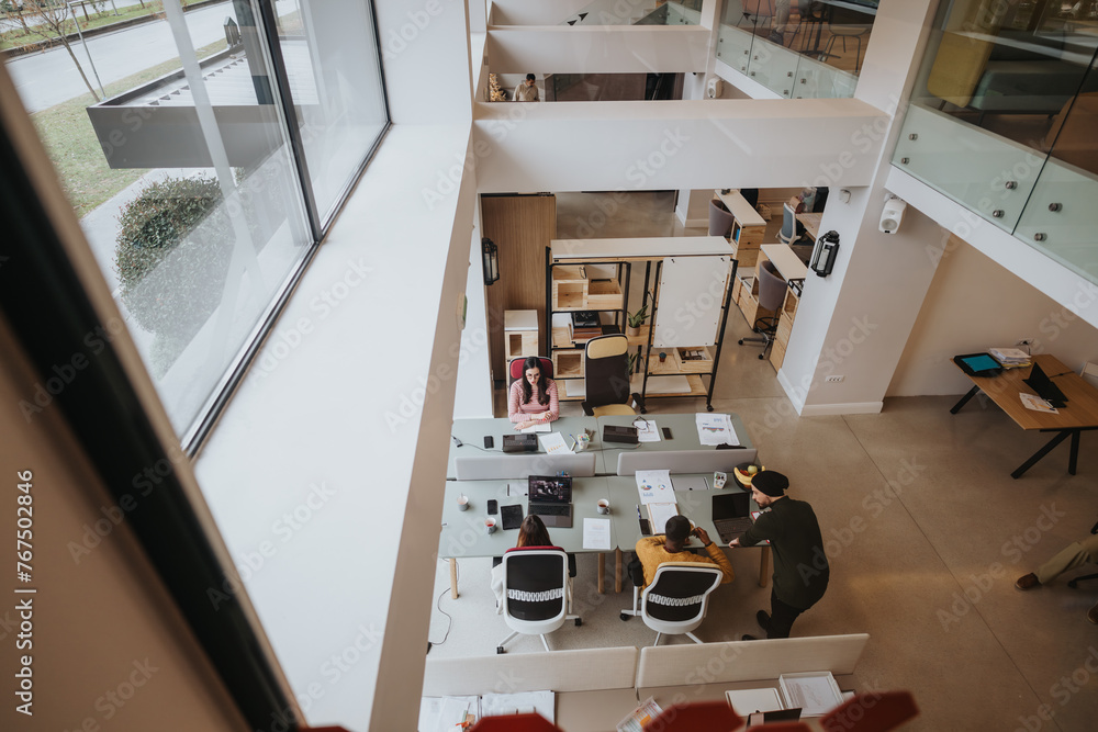 Overhead shot captures a collaborative atmosphere in a well-lit, modern ...
