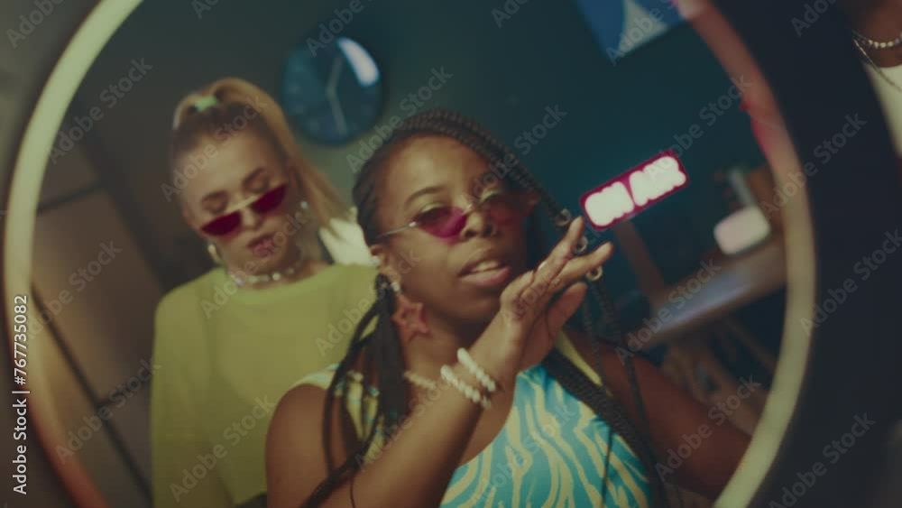 Medium slowmo of young African American guy with two multiracial girls ...