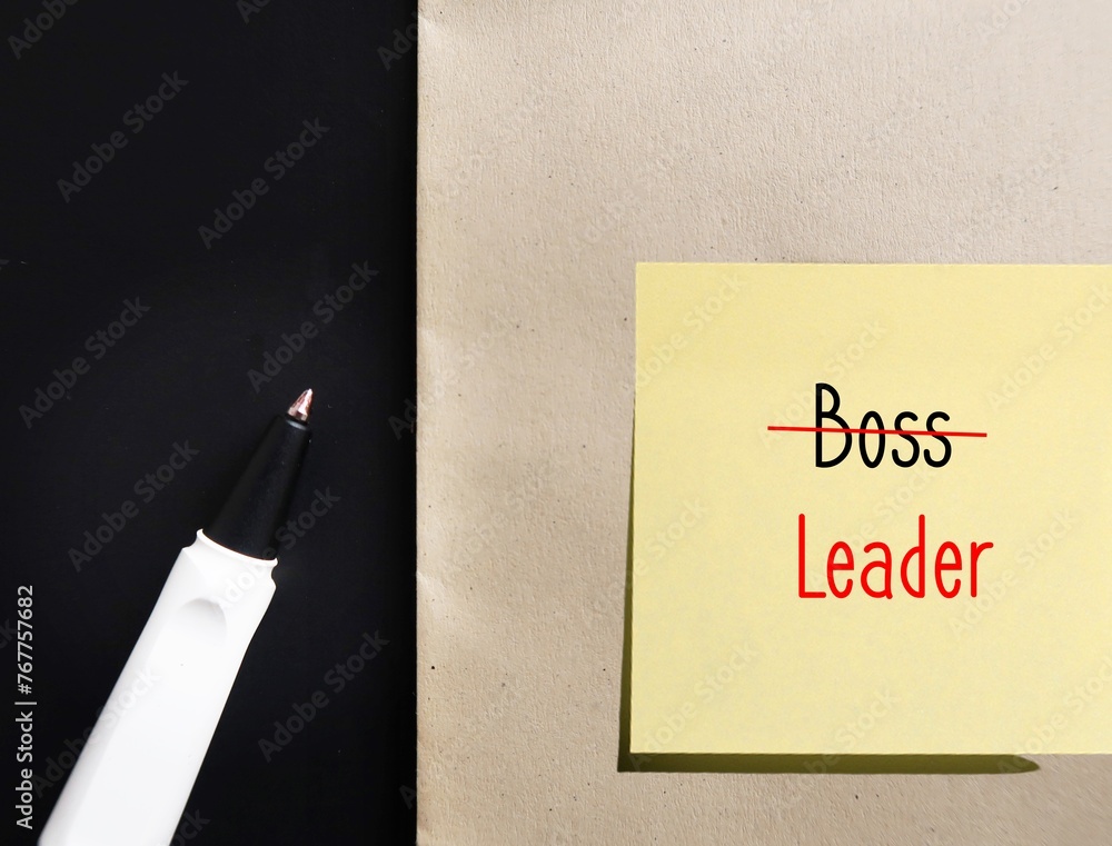 Yellow note with handwritten text BOSS replaced with LEADER, means ...