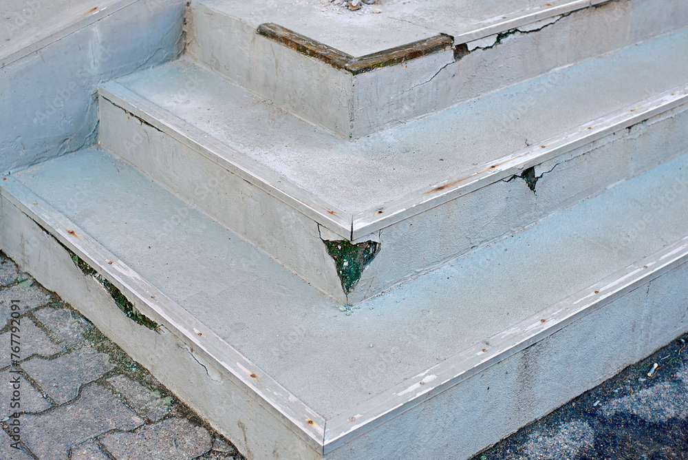 Porch with steps with cracked cement and plaster. Cracked stair steps ...
