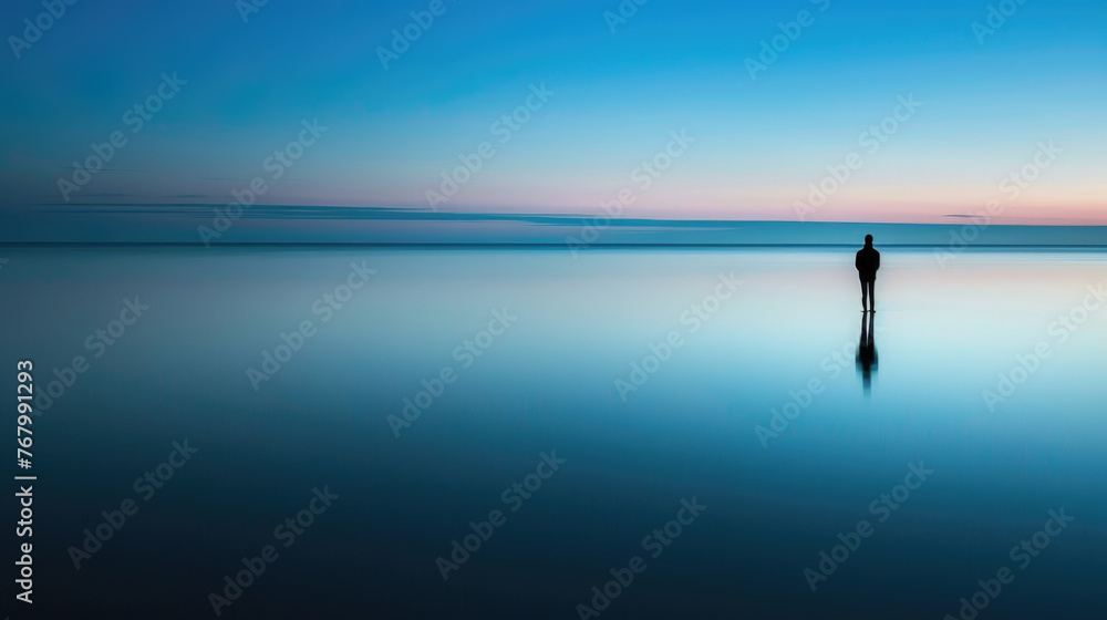 Person standing alone amidst expansive water, demonstrating solitude ...