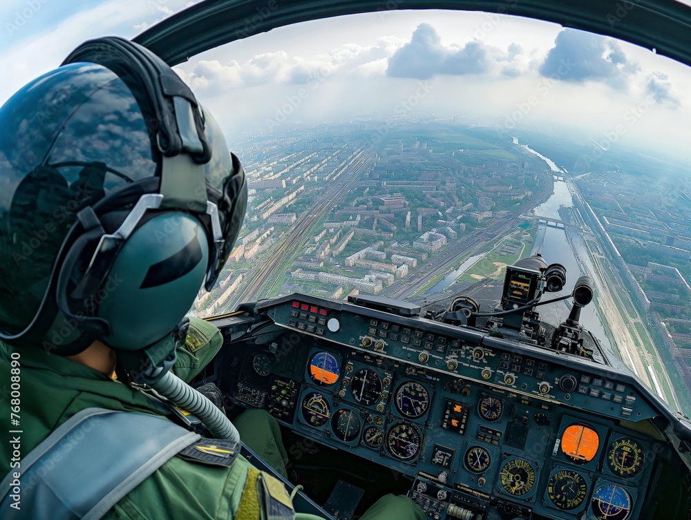A pilot in a flight helmet seen from behind, overlooking a sprawling ...