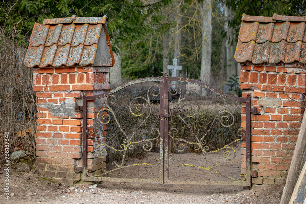 old cemetery gate with pylons made of red bricks. Lielplatones kapi ...