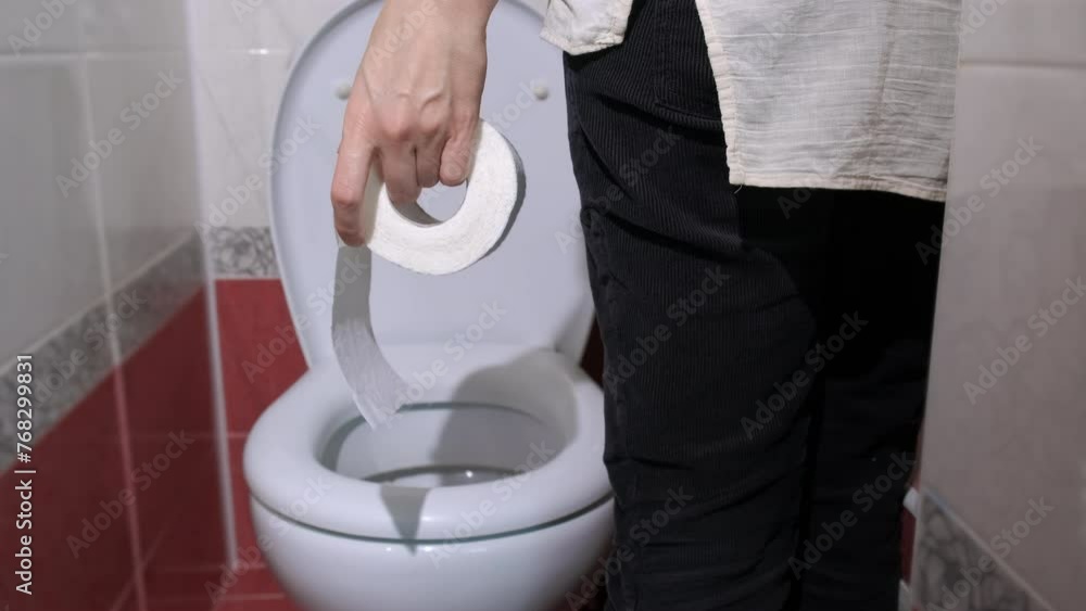 Lady pissing in the toilet. A view of female with toilet paper stand by ...