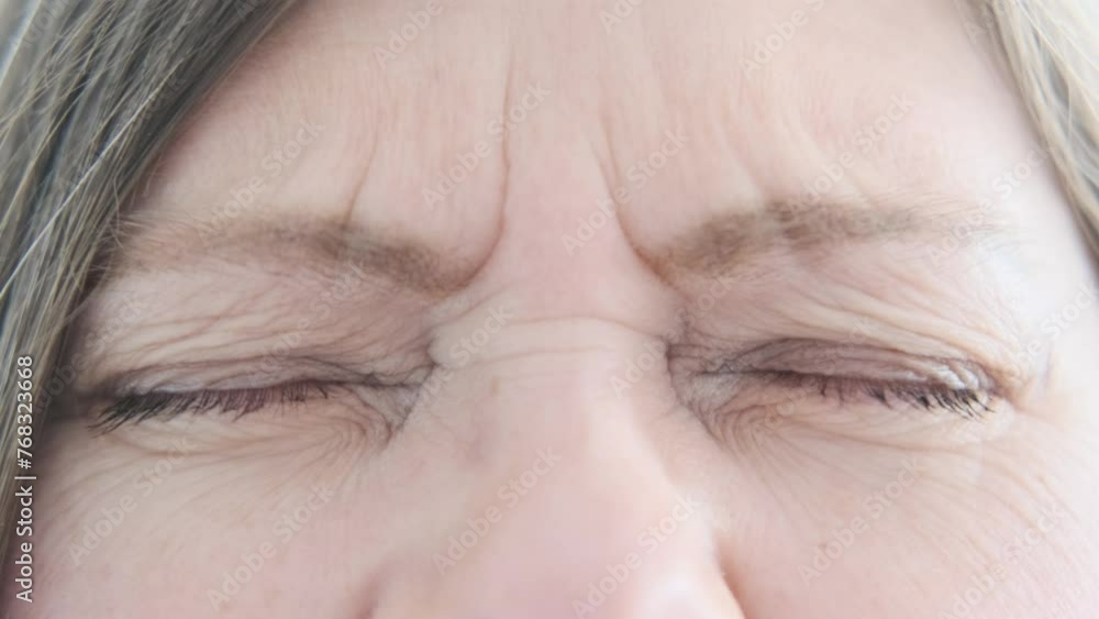 close up part of mature female face, woman 50-55 years old looks ...