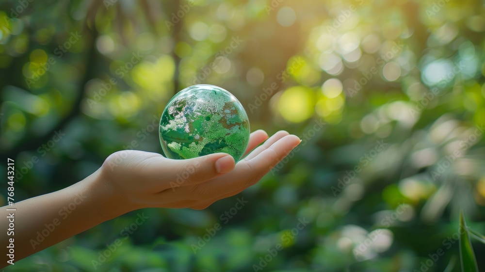 Human hand holding green earth with environmental icons sustainable ...