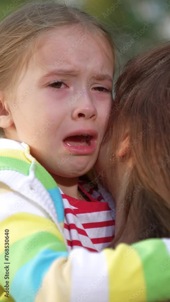little child cries, tears child face, mother calms capricious kid girl ...
