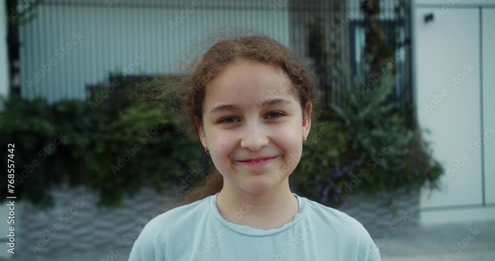 Portrait child happy beautiful child wearing a delightful smile, looks ...