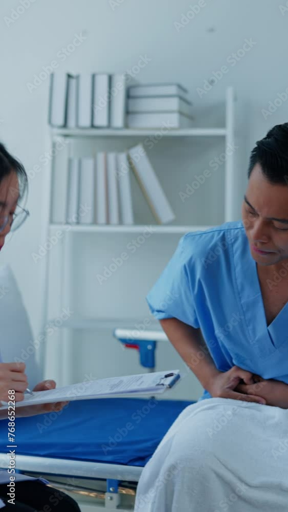 Vertical footage of Doctor examining patient stomach ache by touching ...